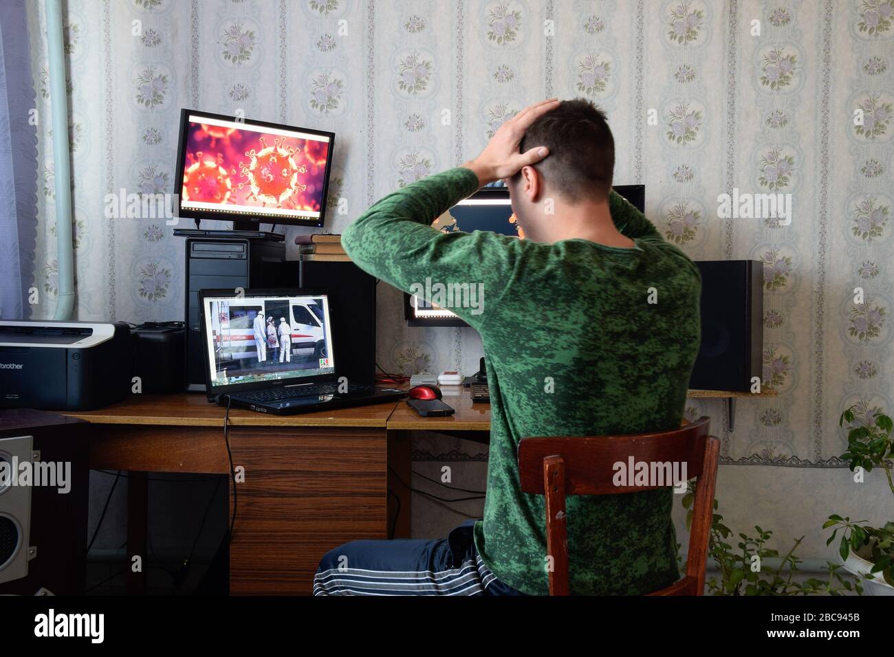 Krasnodar, Russia - April 02, 2020: A man sits at computer monitors and ...