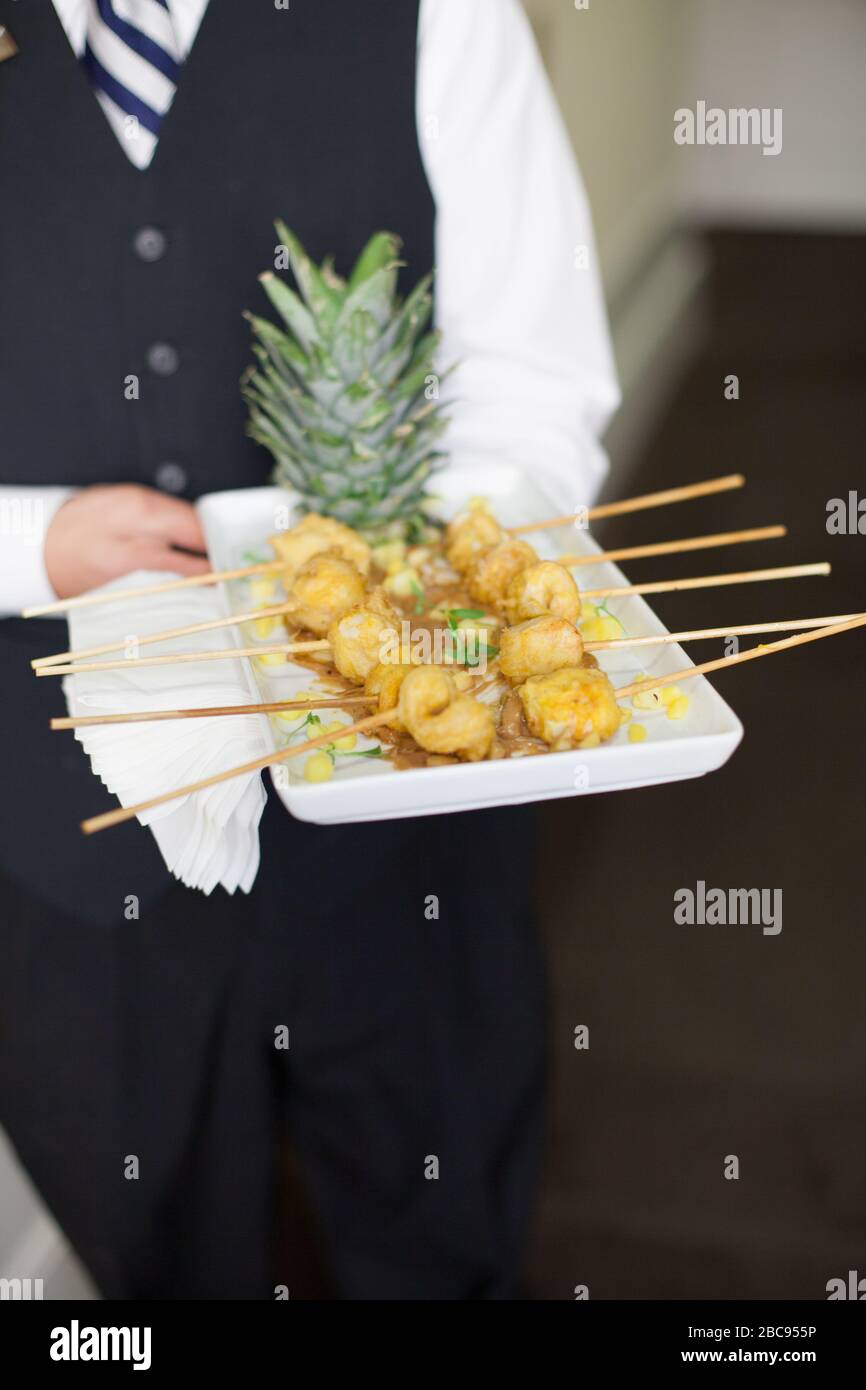 appetizers in tray being passed by formal server Stock Photo - Alamy