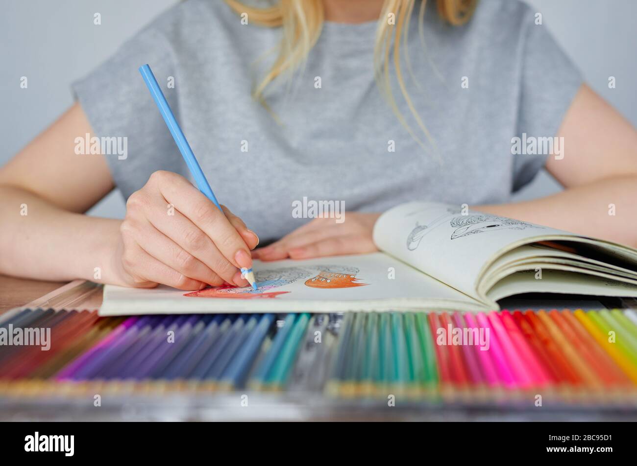 Portrait of lovely girl drawing with colorful pencils. Beautiful woman ...