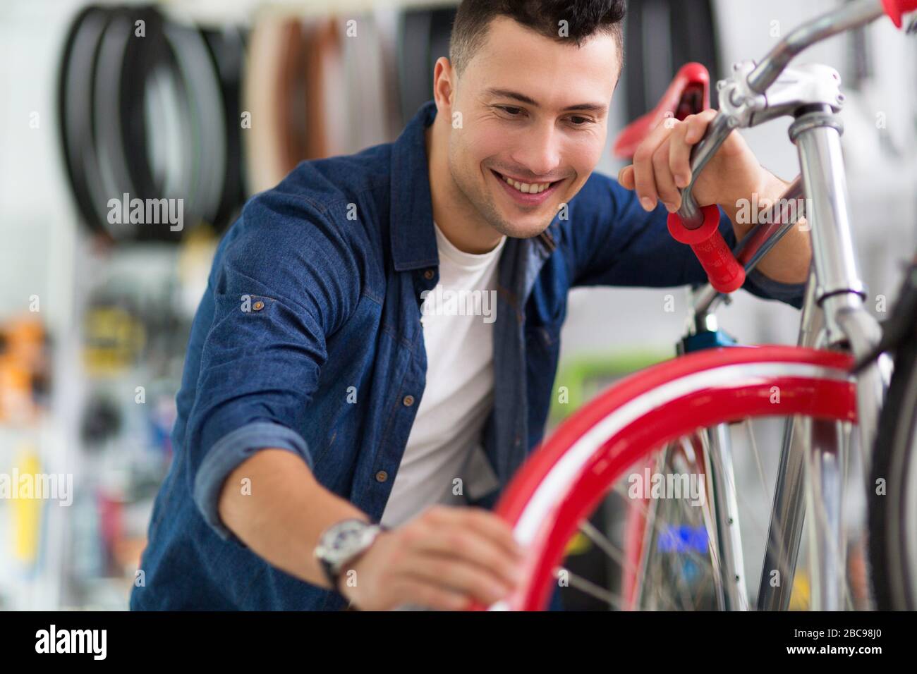 Man working in bicycle shop hi-res stock photography and images - Alamy