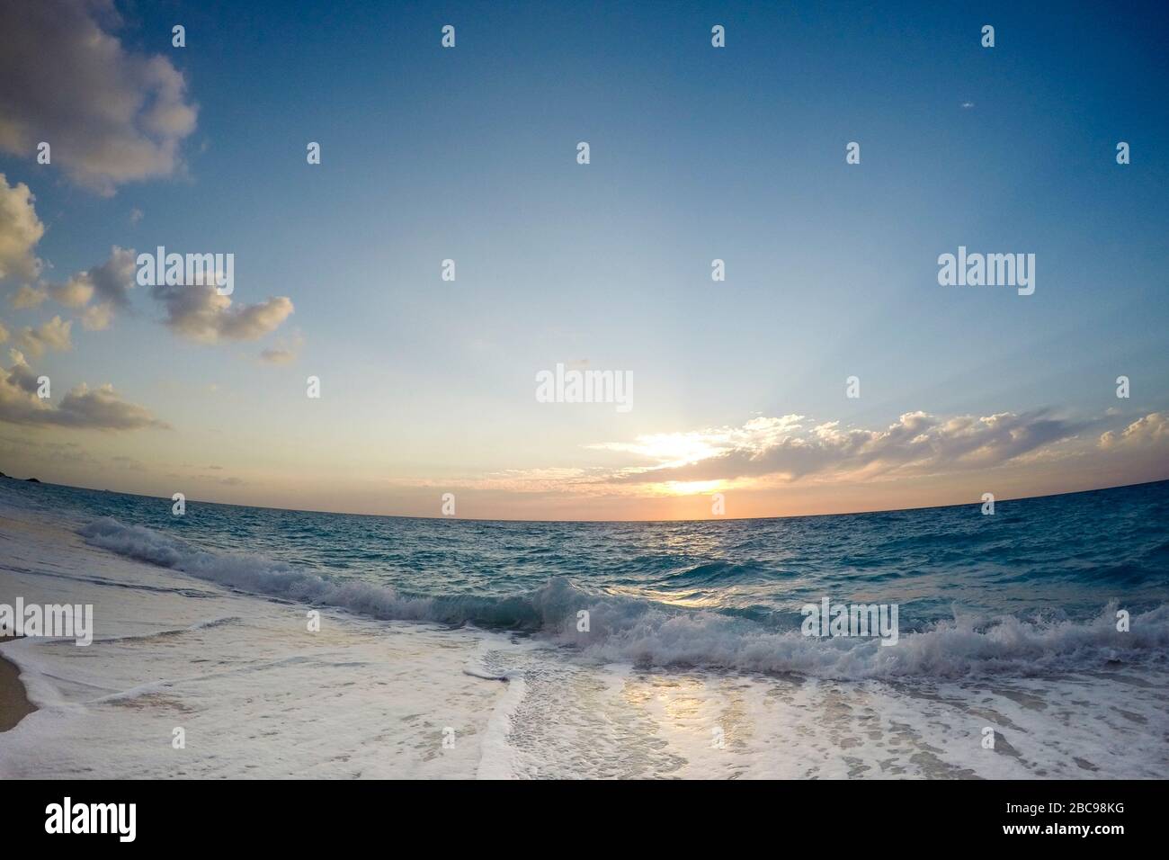Lefkada island sunset by the sea waves clouds landscape Stock Photo - Alamy