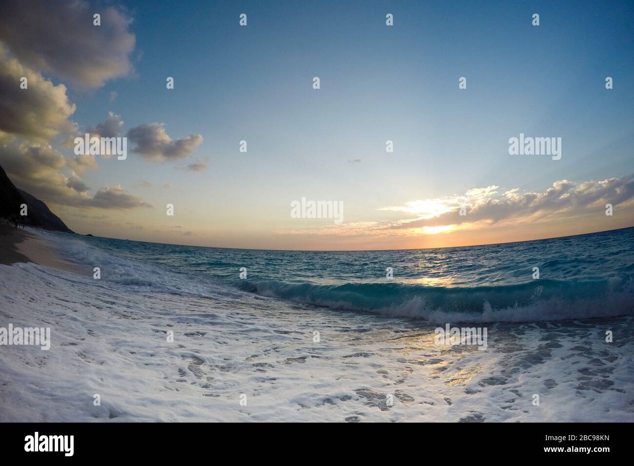 Lefkada island sunset by the sea waves clouds landscape Stock Photo - Alamy