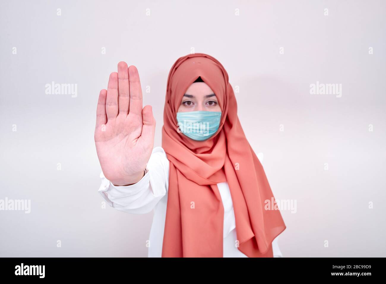 Muslim girl wearing surgical mask for protection. Hijab woman take a ...