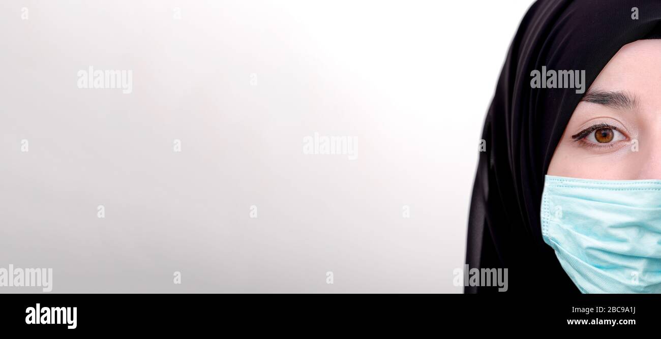 Muslim girl wearing surgical mask for protection. Hijab woman take a ...