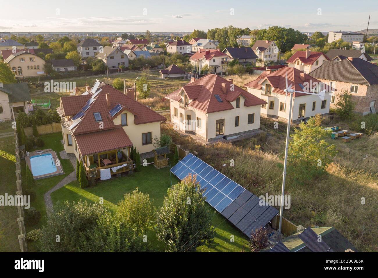 Aerial view of a residential private house with solar panels on roof ...