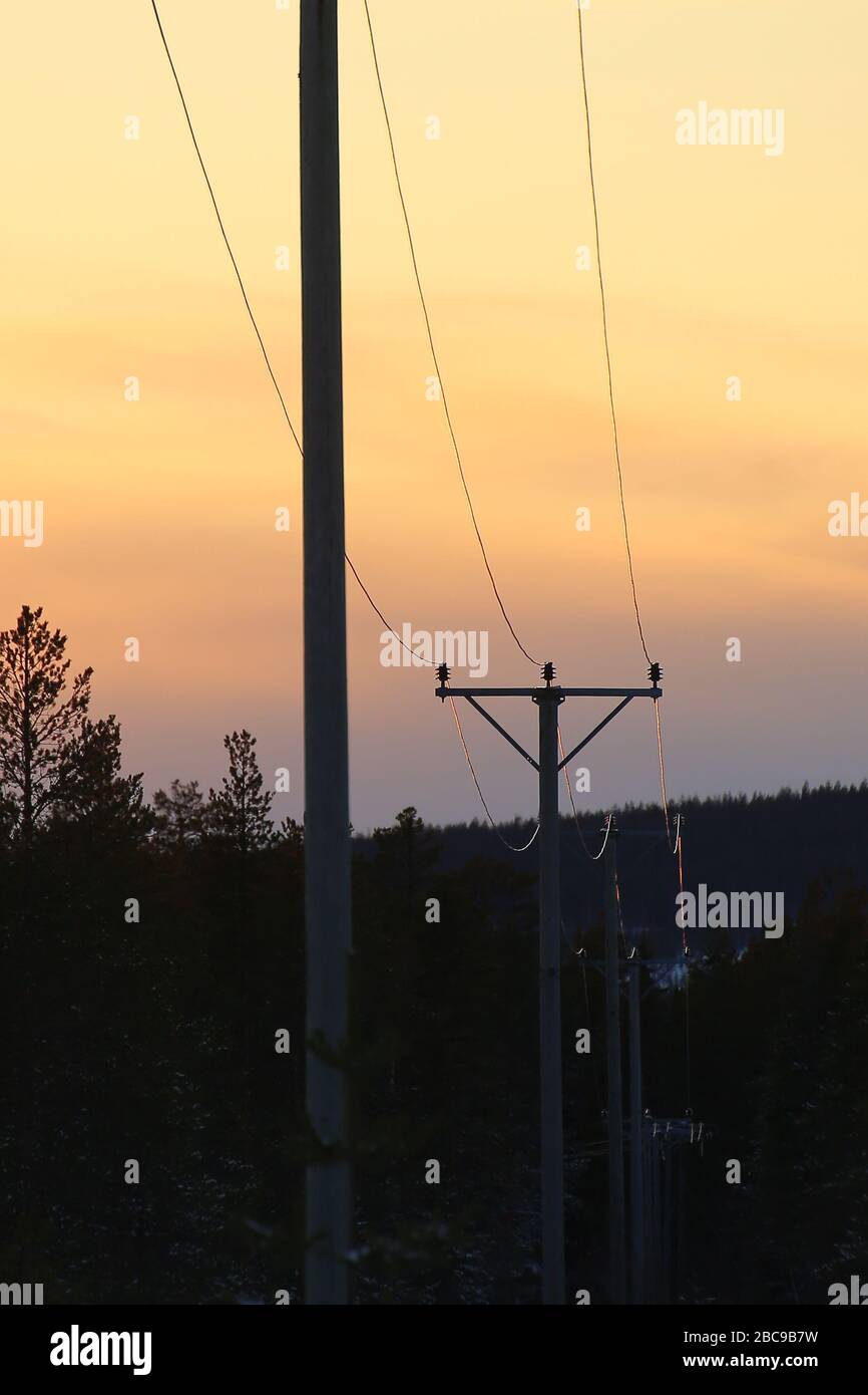 Power lines reflection evening sun in Swedish winter Stock Photo - Alamy
