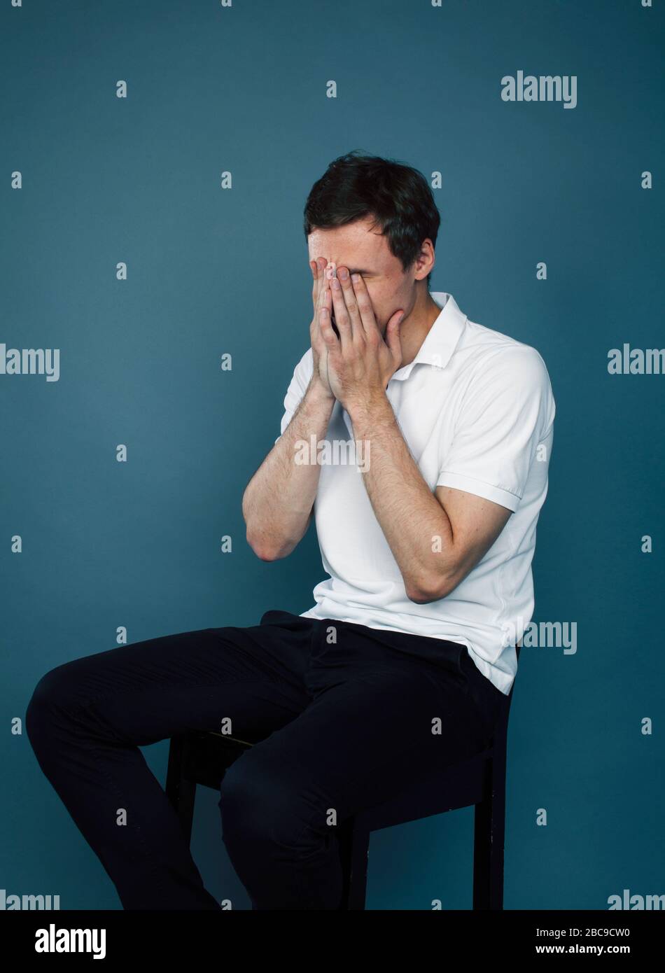 young goofy man with pimples pointing gesturing in studio, stupid ...