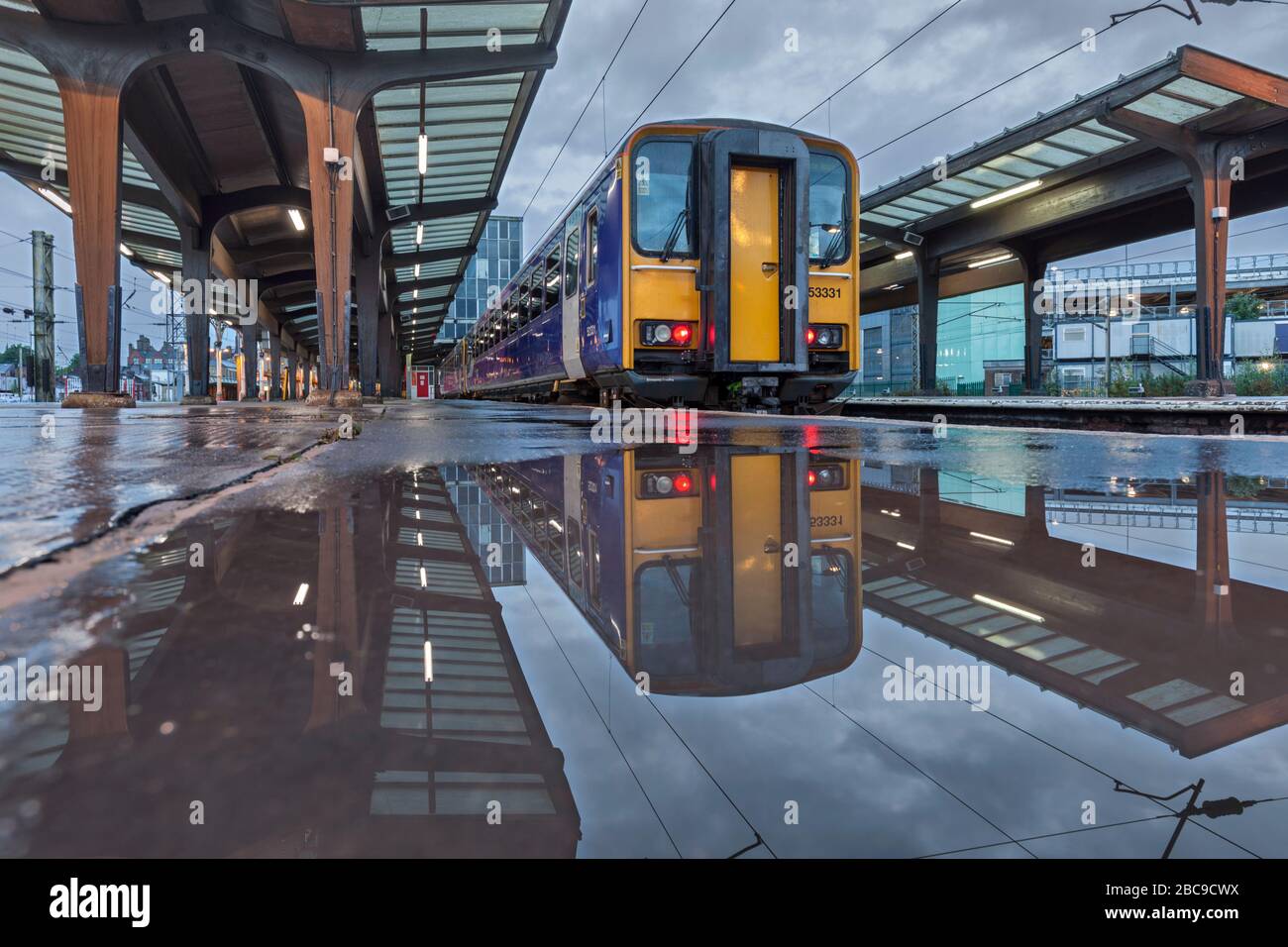 2 Northern Rail class 153 sprinter trains reflected in a puddle at ...