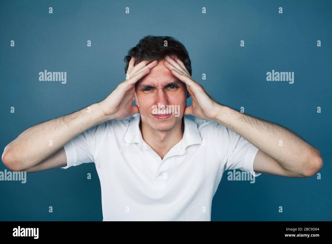 young goofy man with pimples pointing gesturing in studio, stupid ...