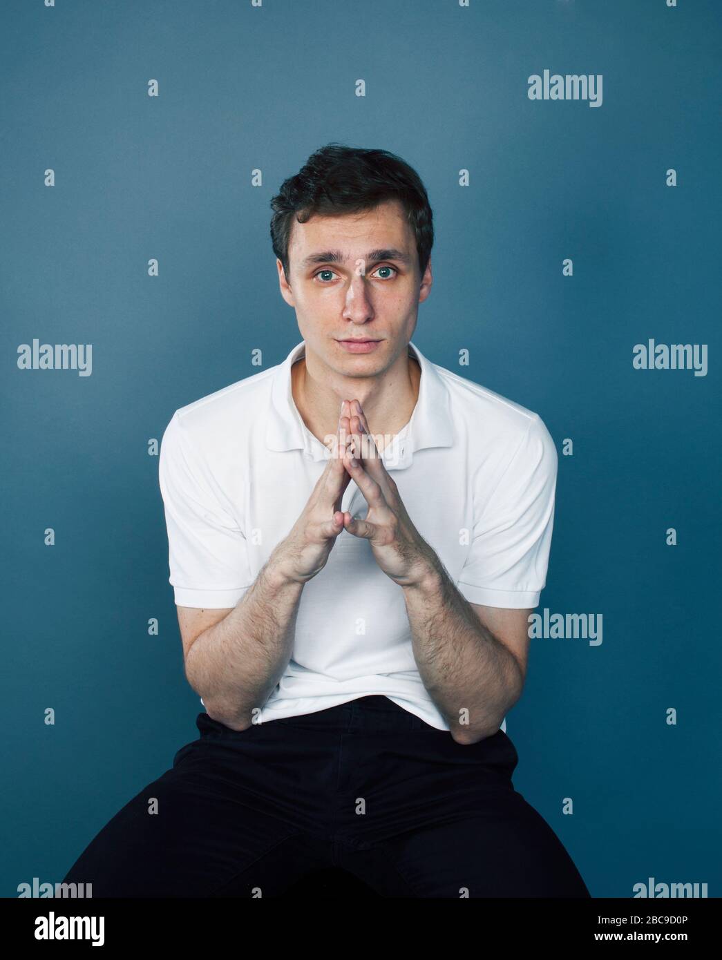 young goofy man with pimples pointing gesturing in studio, stupid ...