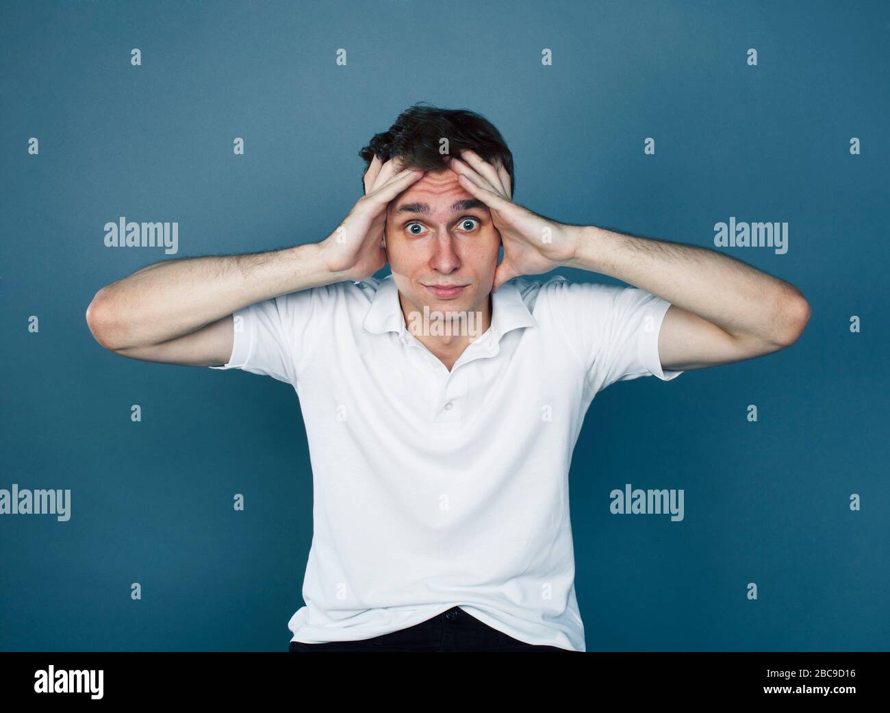 young goofy man with pimples pointing gesturing in studio, stupid ...