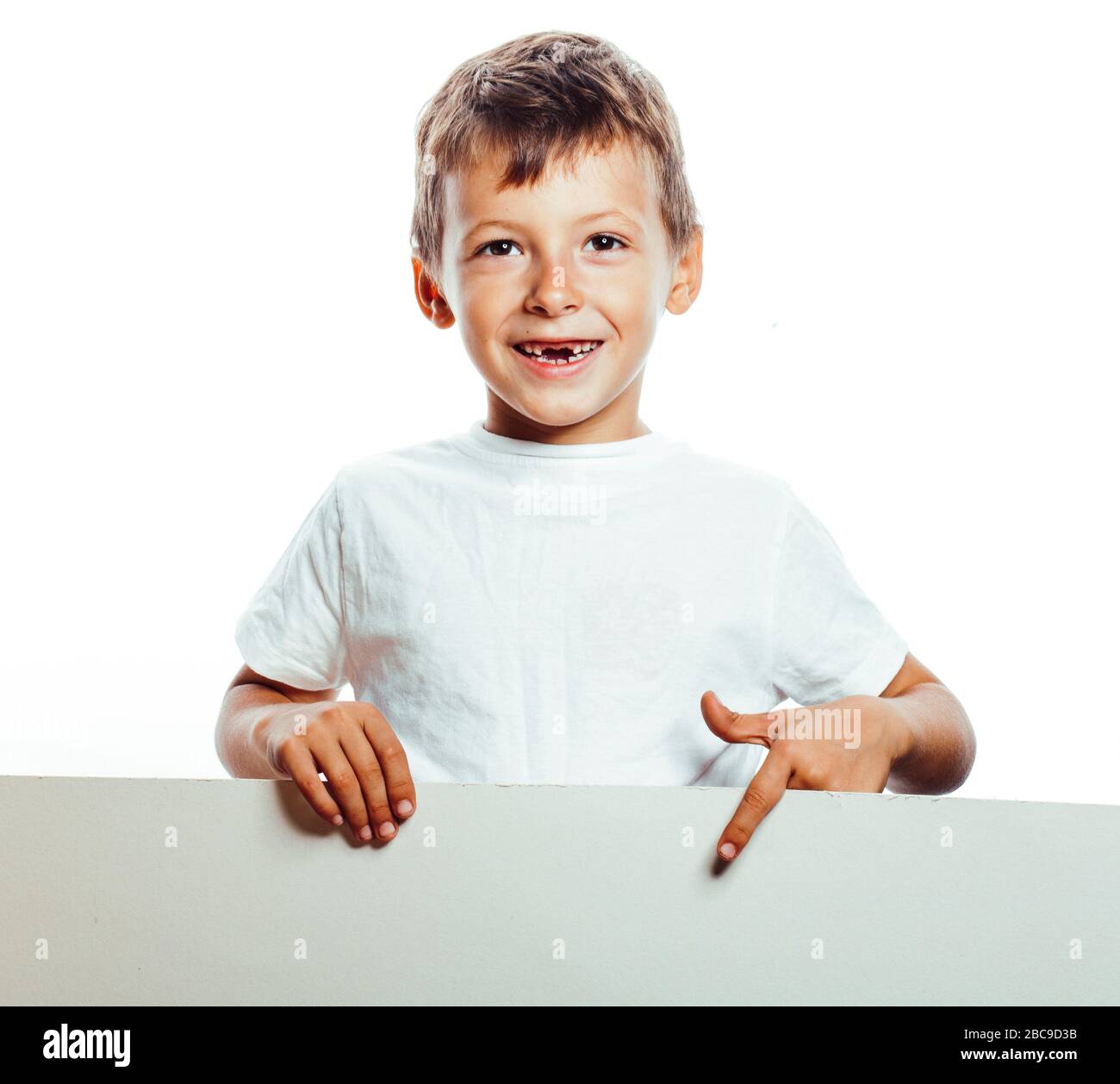 young pretty little boy wondering face gesturing, pointing isolated on ...