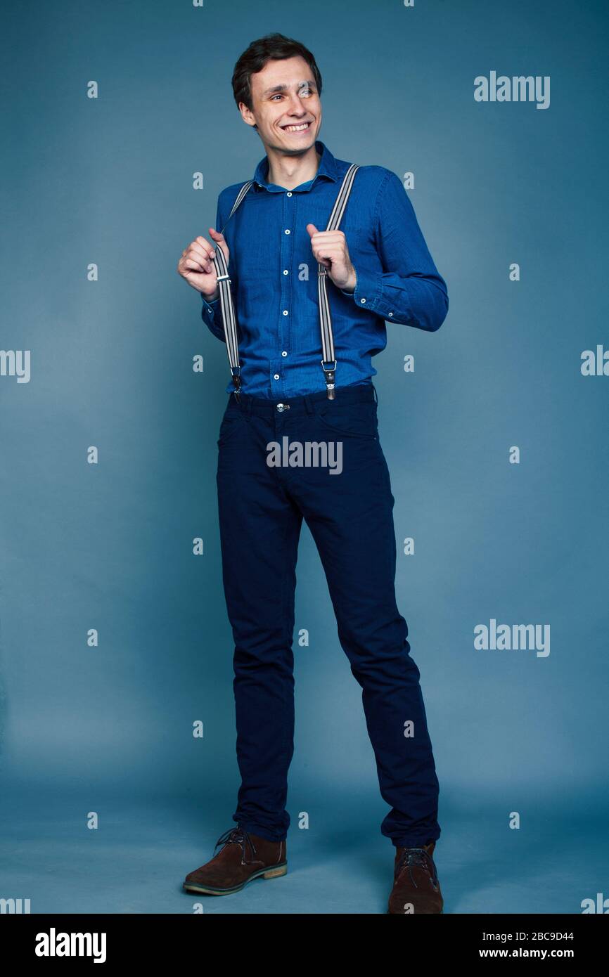 young goofy man with pimples pointing gesturing in studio, stupid ...