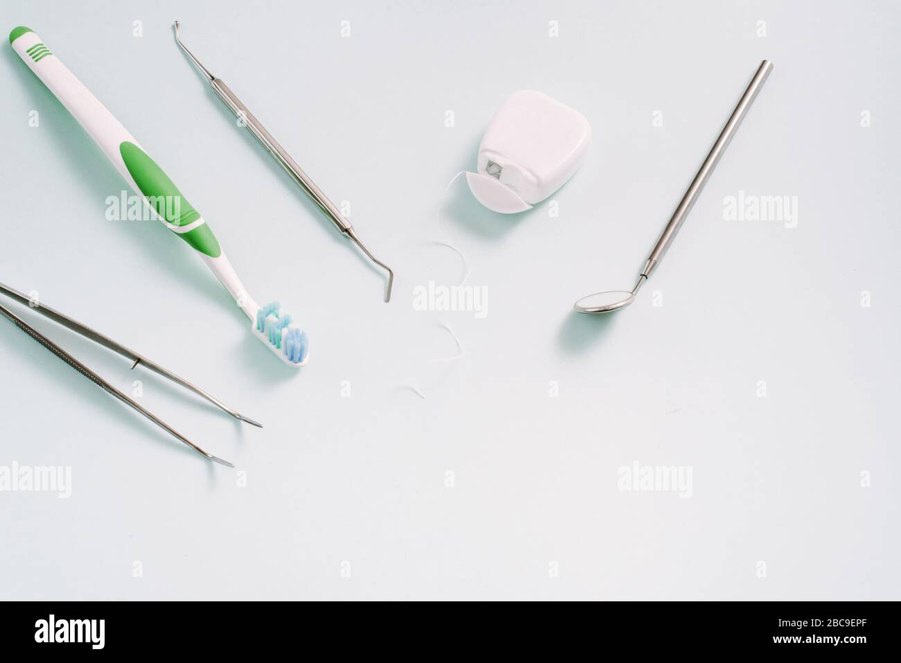 Dental tools, toothbrush and thread on a blue background. The concept ...