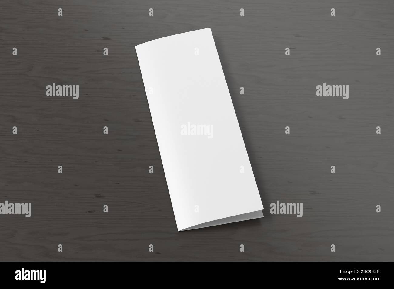 Blank vertical A4 leaflet on black wooden background. Bi-fold or half ...