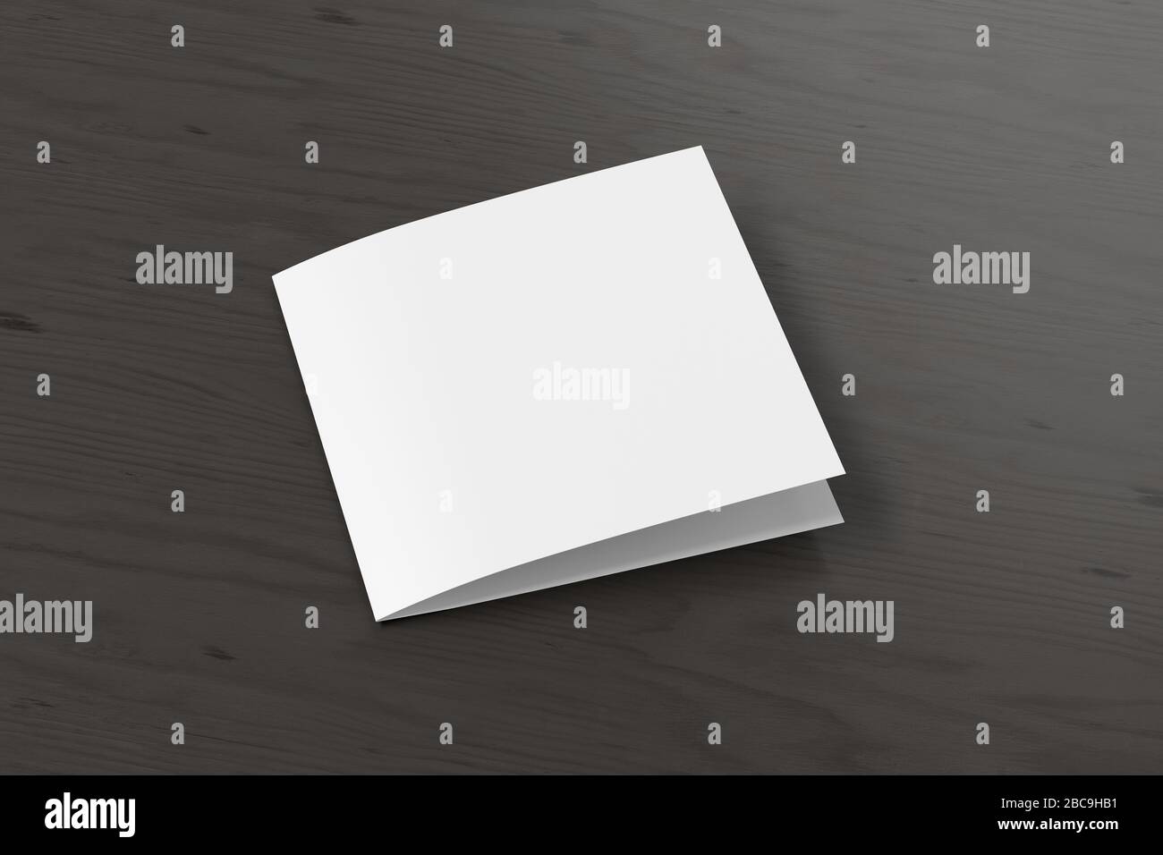 Blank square pages leaflet on black wooden background. Bi-fold or half ...