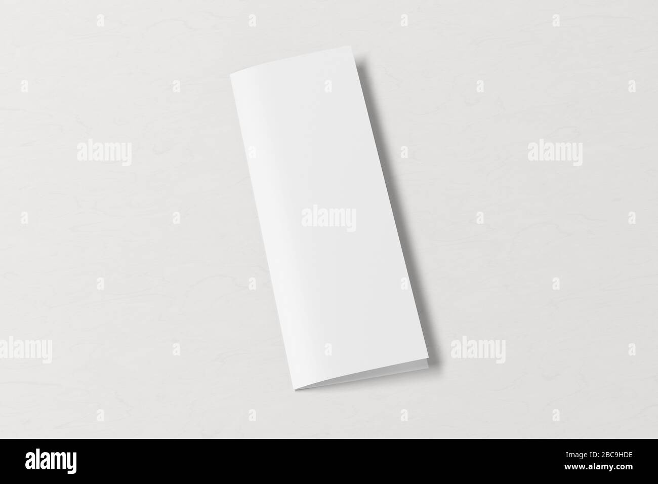 Blank vertical A4 leaflet on white wooden background. Bi-fold or half ...