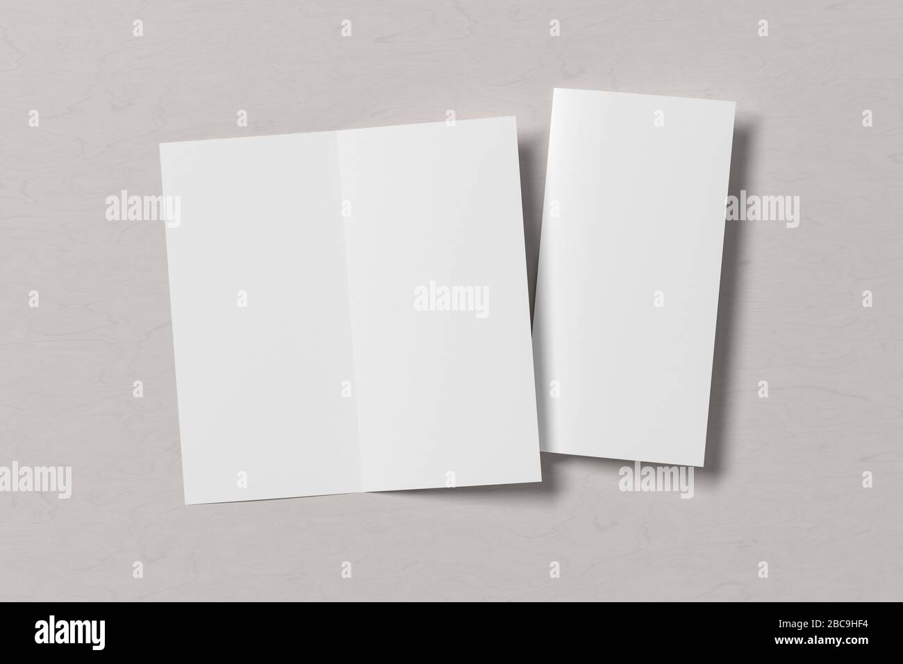 Blank square leaflet on white wooden background. Bi-fold or half-fold ...