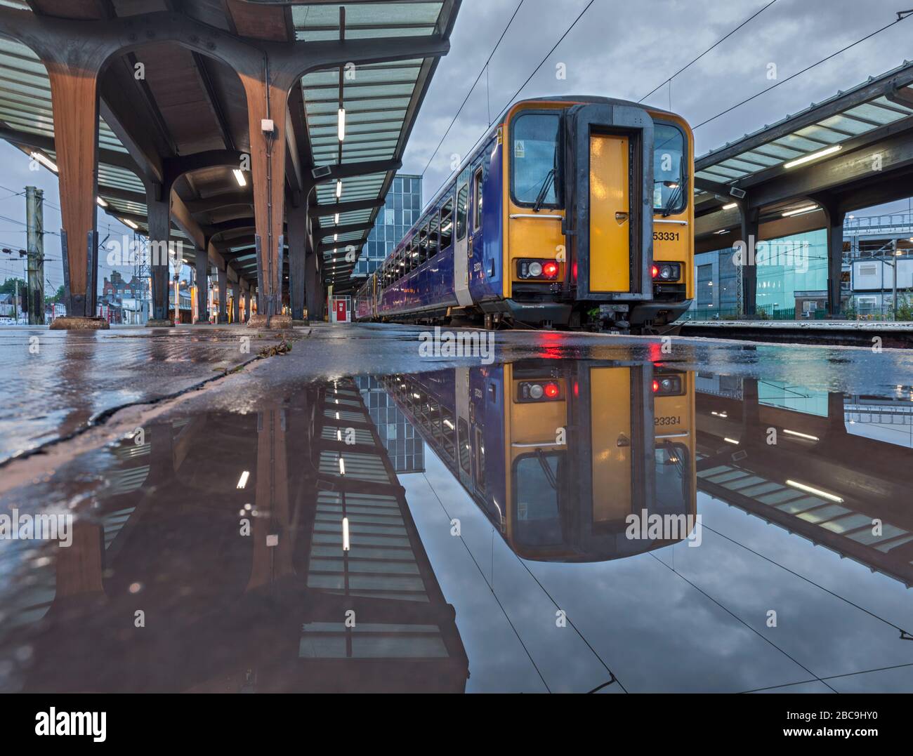 2 Northern Rail class 153 sprinter trains reflected in a puddle at ...