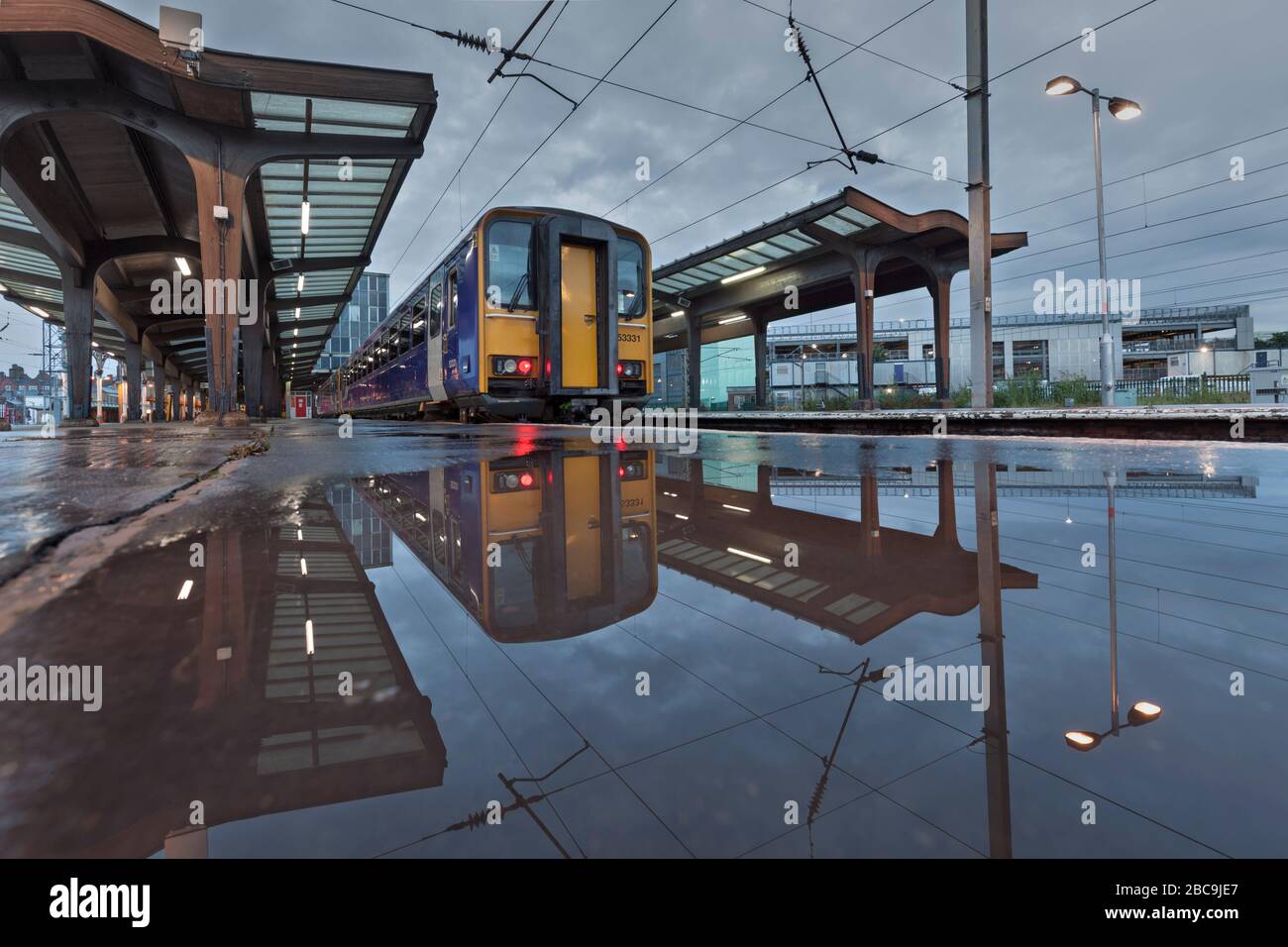 2 Northern Rail class 153 sprinter trains reflected in a puddle at ...