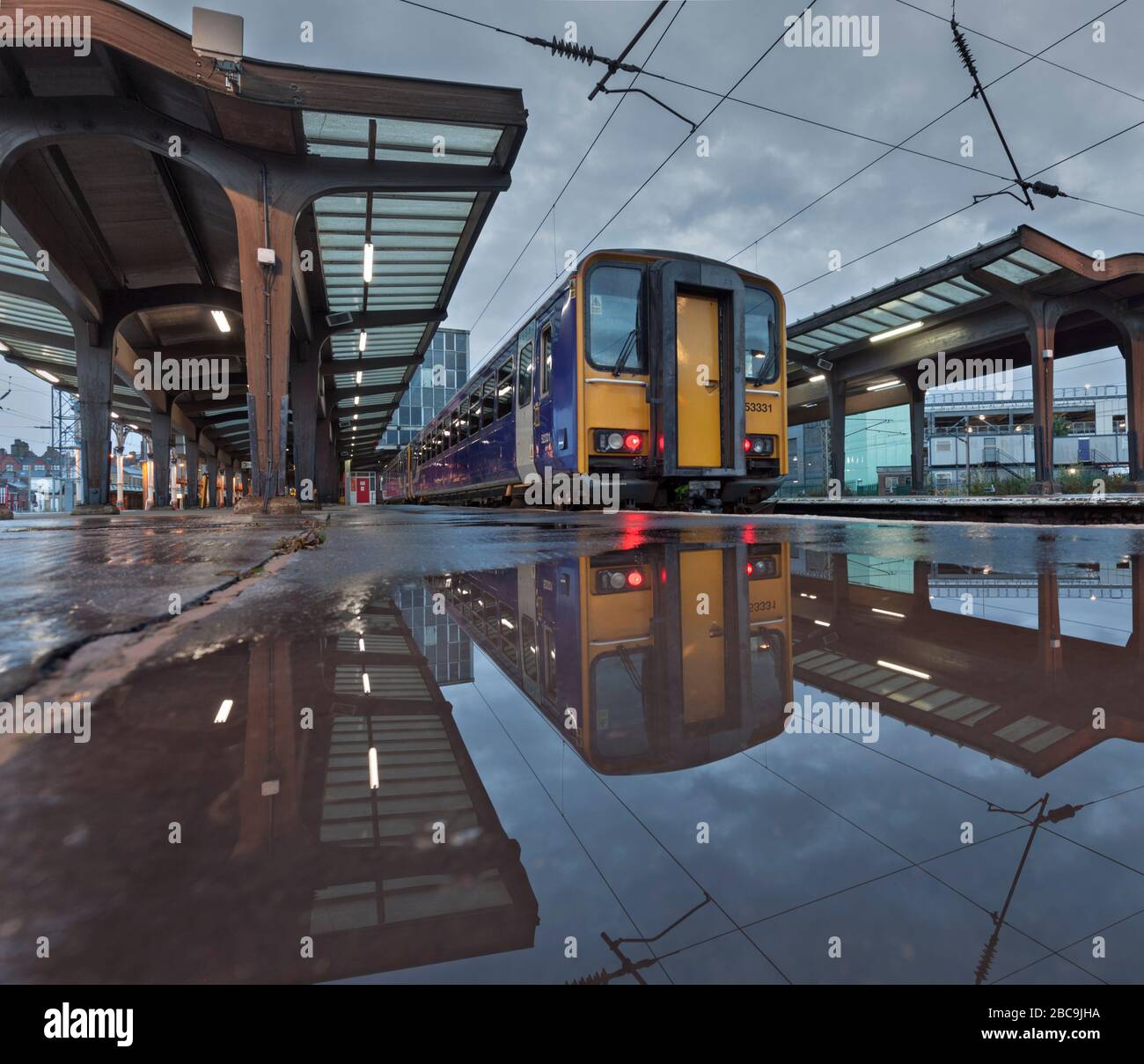 2 Northern Rail class 153 sprinter trains reflected in a puddle at ...