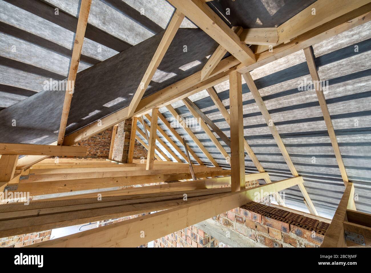 Attic of a building under construction with wooden beams of a roof ...