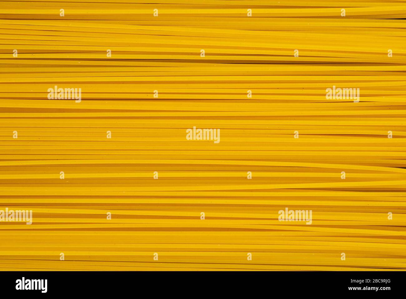 Yellow long spaghetti background close-up. Macro photography Stock ...