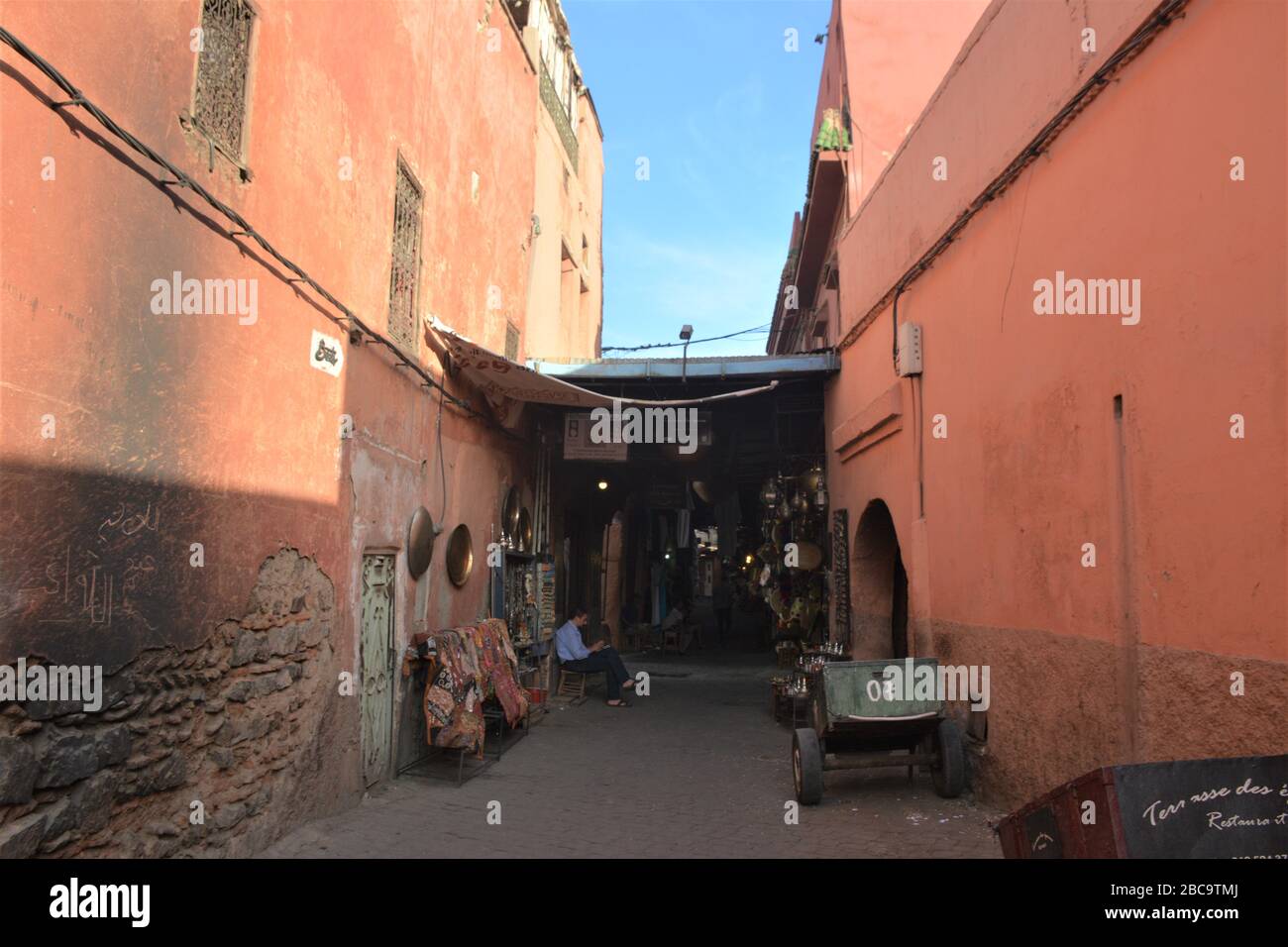 The narrow streets of Marrakech medina provide protection from the sun ...