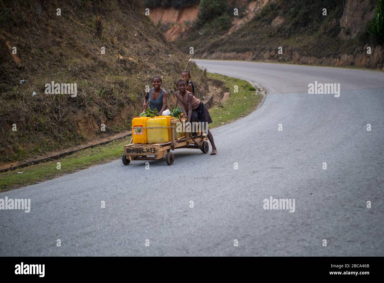 Africa, Madagascar, Ambositra. People wheeling water jugs home Stock ...