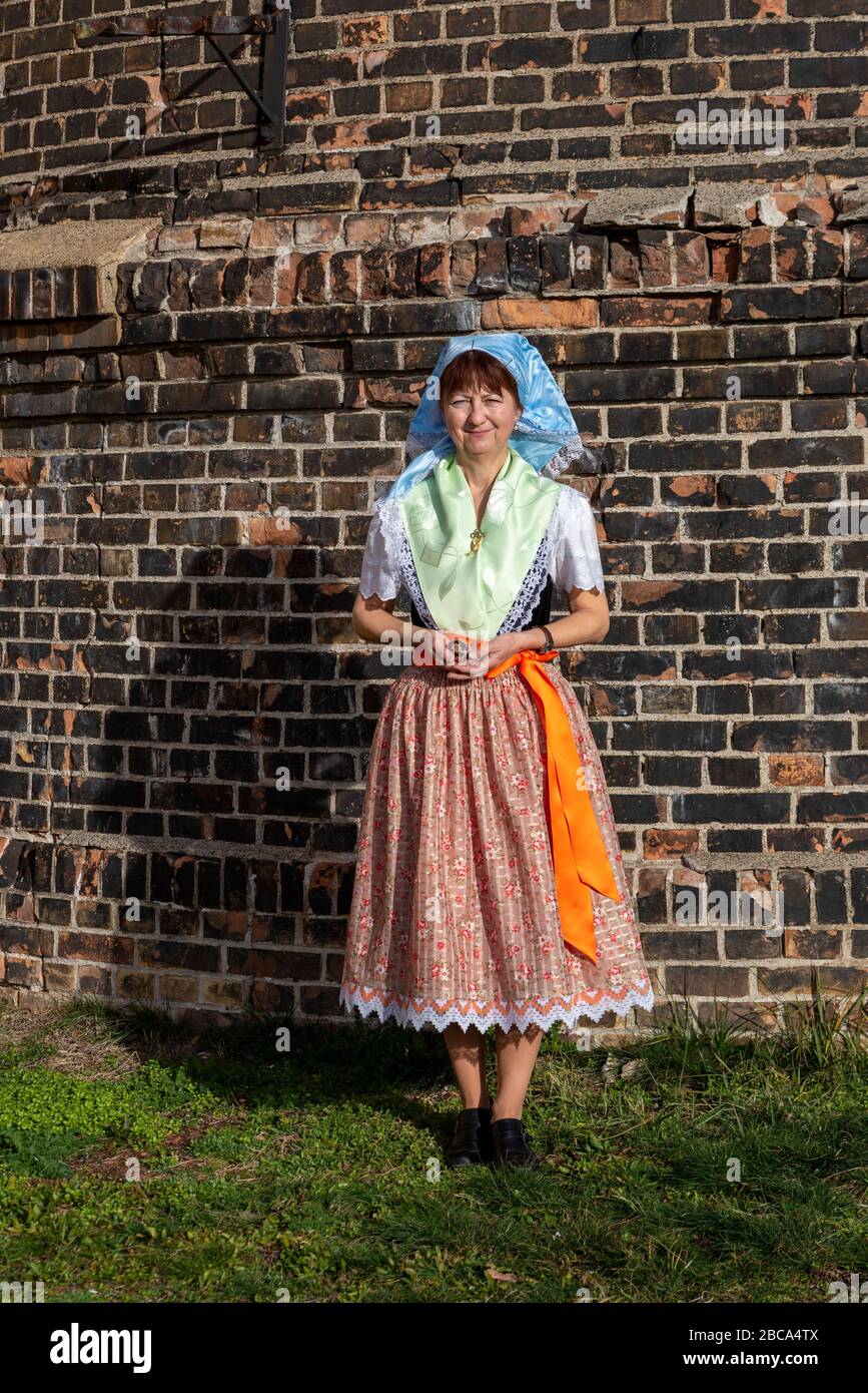 A woman wears the Sorbian costume, holding an ornamented Easter egg in ...