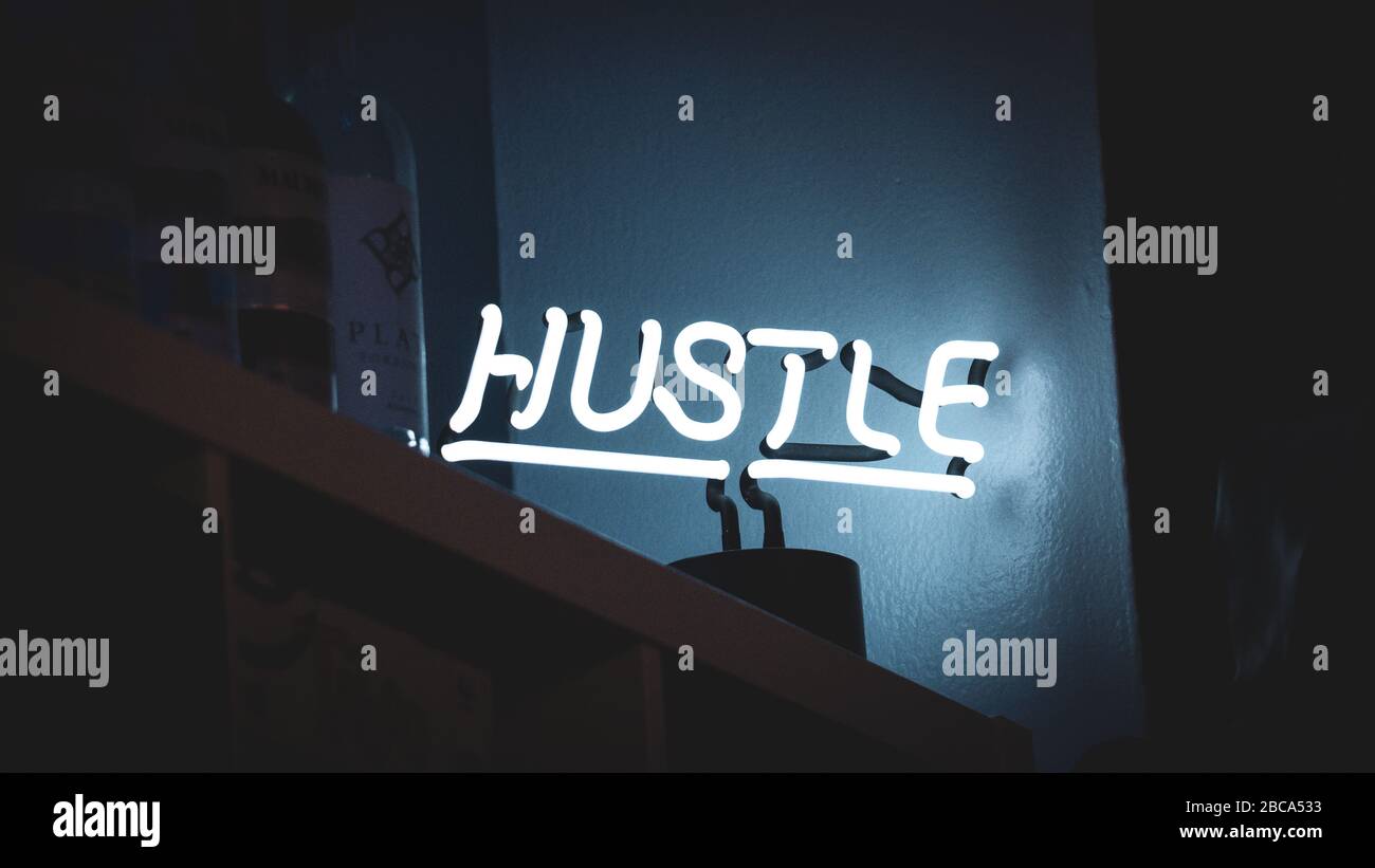 Neon Hustle Lamp glow sign Stock Photo - Alamy
