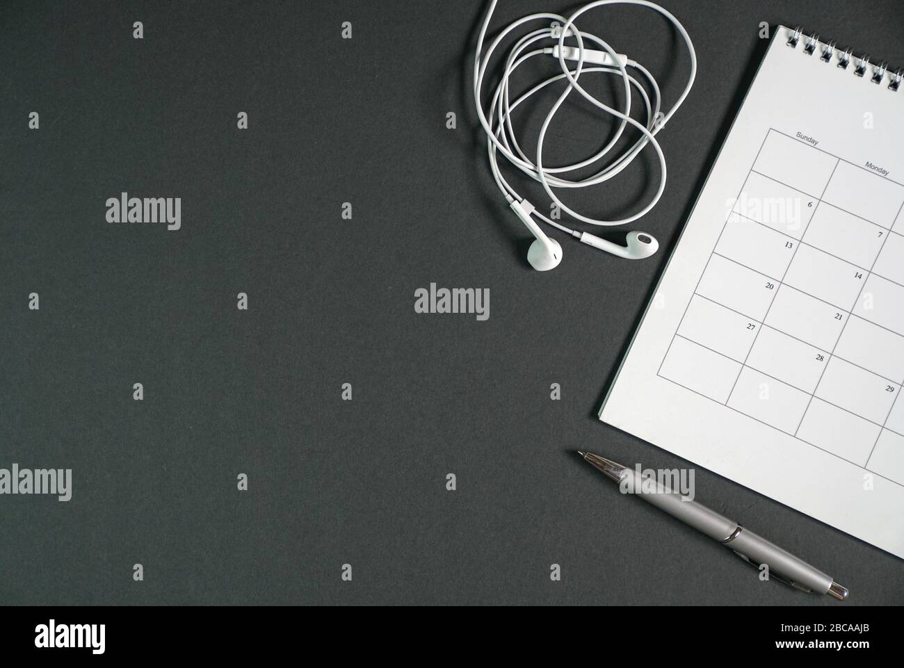 Top view of office table with calendar and ear phones. Copy space Stock ...