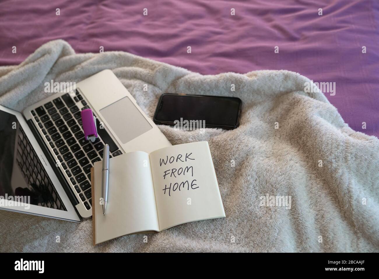 Work from home, text written on notepad. Computer laptop, cellphone and ...