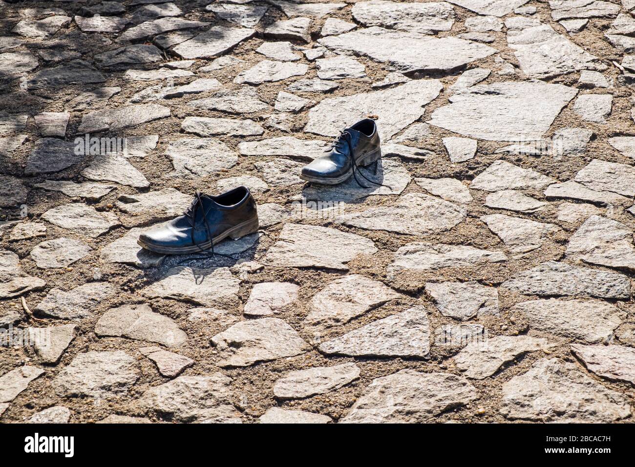 Shoes stand on a natural stone paved path Stock Photo - Alamy
