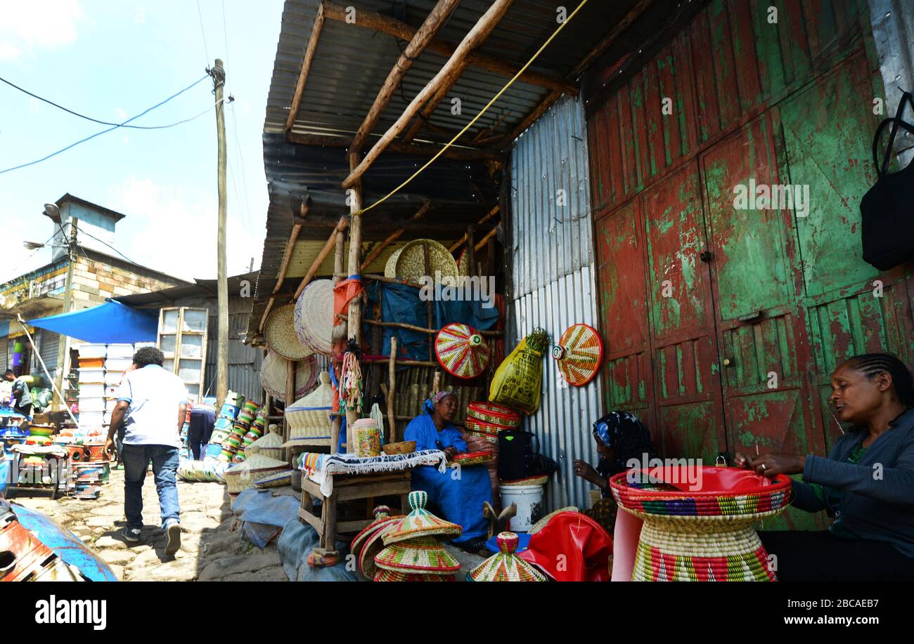 Ethiopian women weaving colorful injera baskets at the Mercato market ...