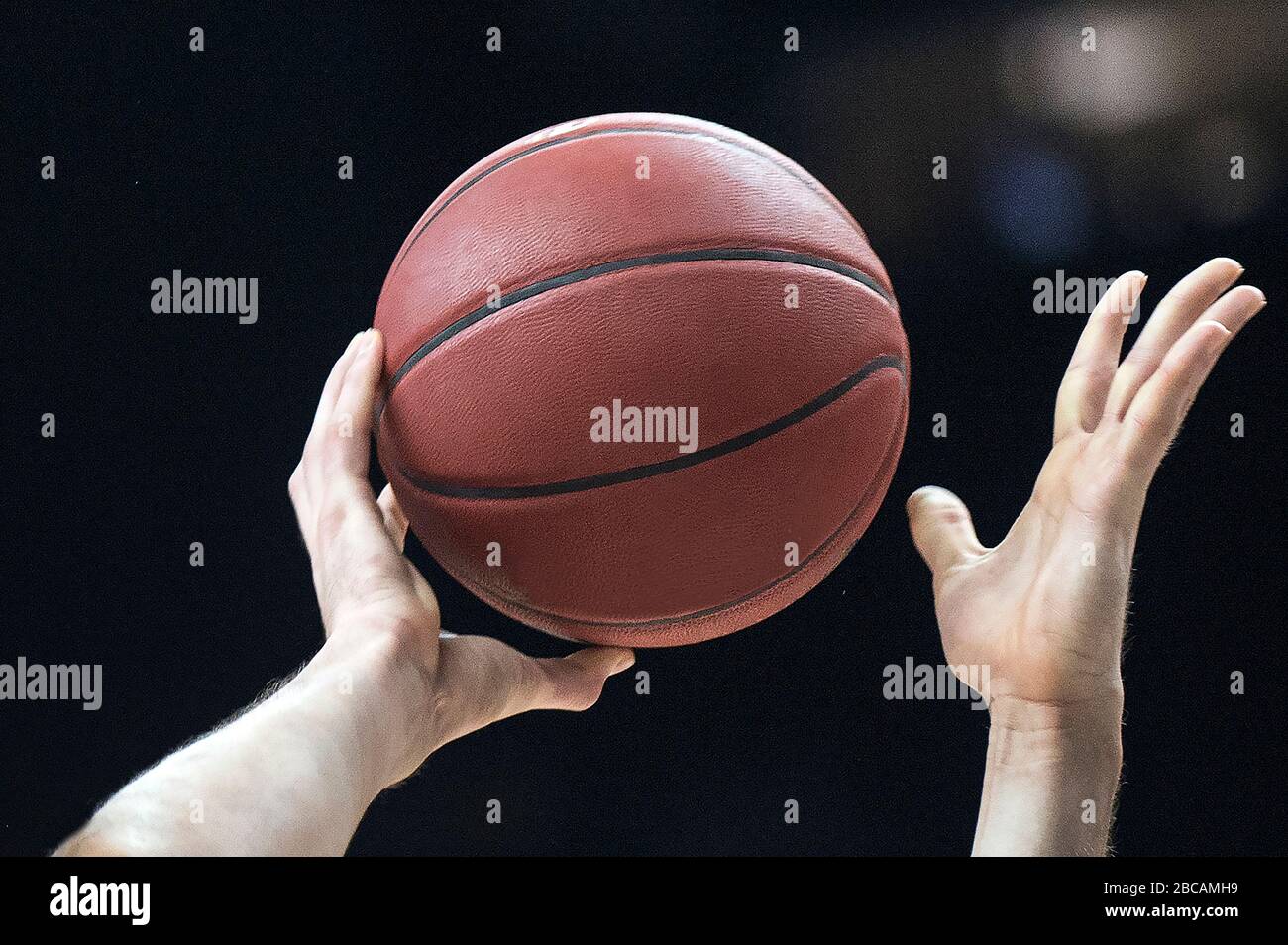 Basketball ball and hands Stock Photo - Alamy