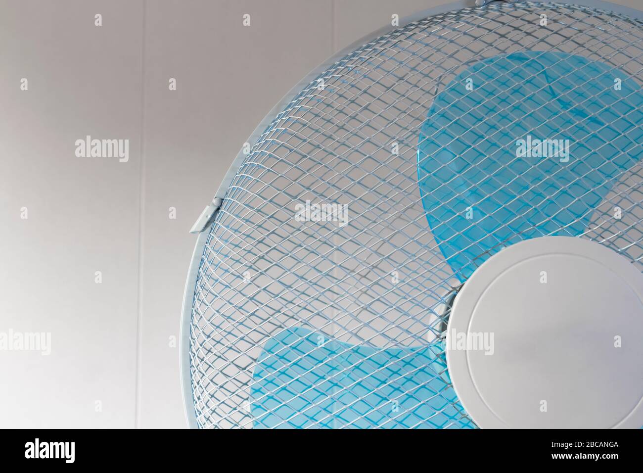 Indoor floor cooling fan. Plastic, blue. It stands near the wall Stock ...