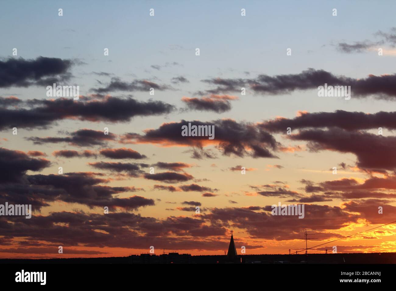 Clouds in the blue sky at sunset or dawn backlit by the sun. Place for ...
