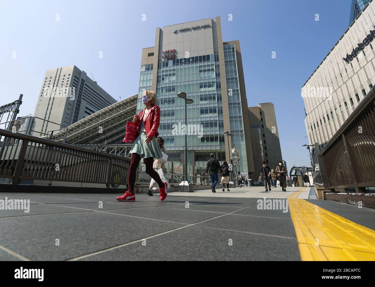 Only a few people are seen on a street in Osaka's Umeda commercial ...