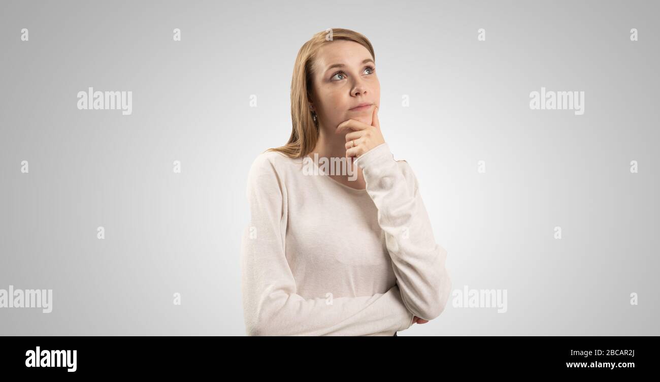 a woman lost in thought supports her chin with her hand Stock Photo - Alamy