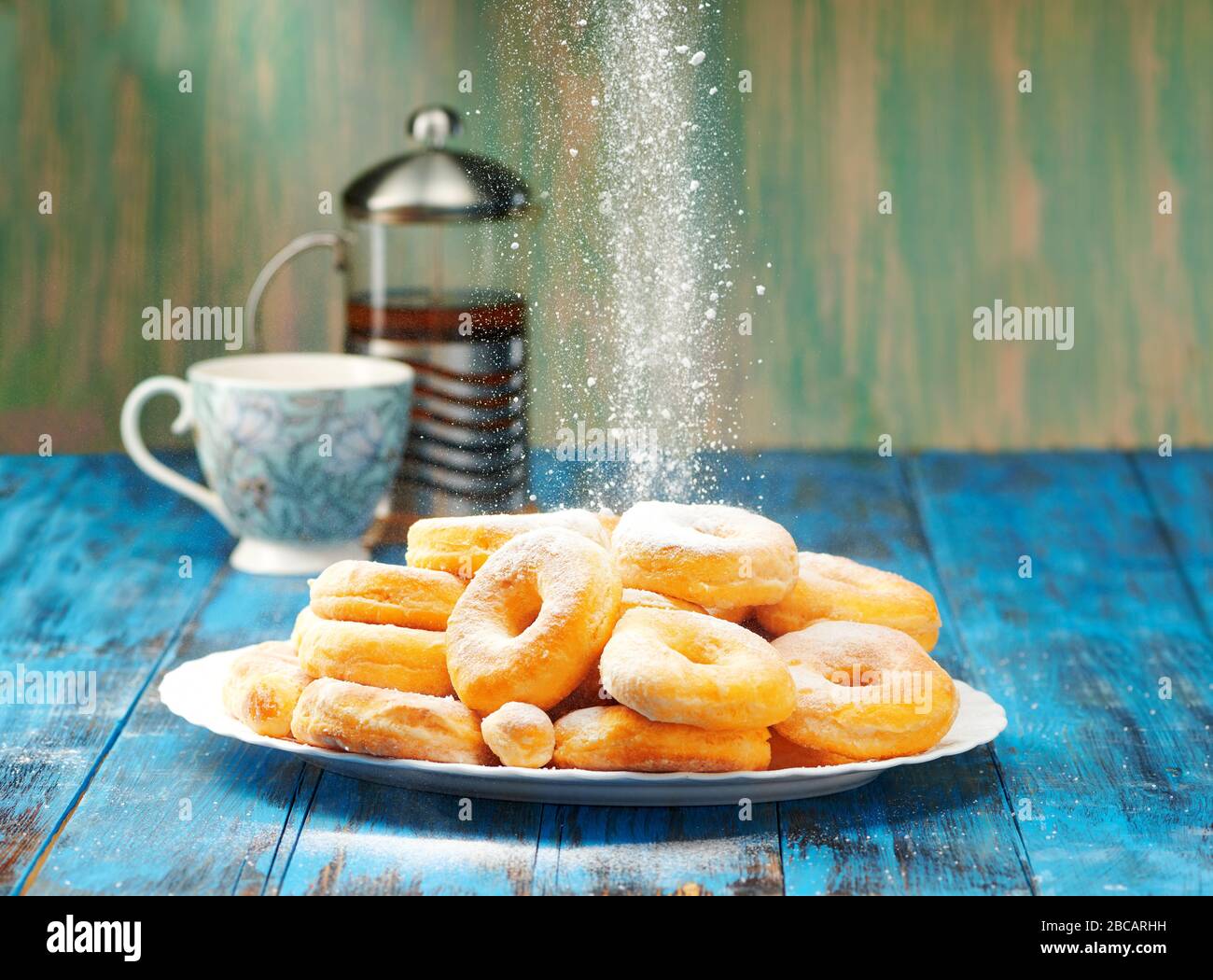 Homemade donuts with tea in the afternoon a wooden blue background ...