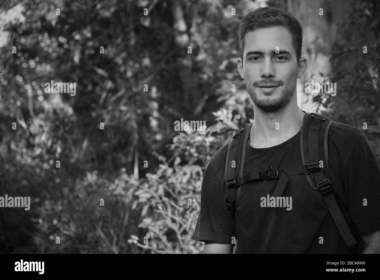 a model man dressed as a hiker or walker with a technical bag over a ...