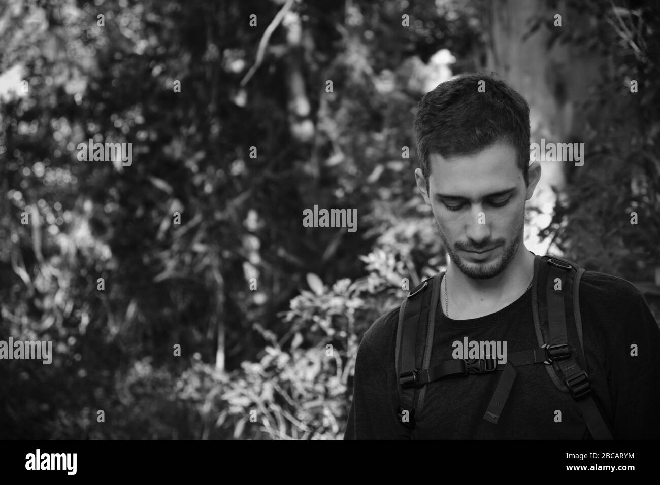 a model man dressed as a hiker or walker with a technical bag over a ...