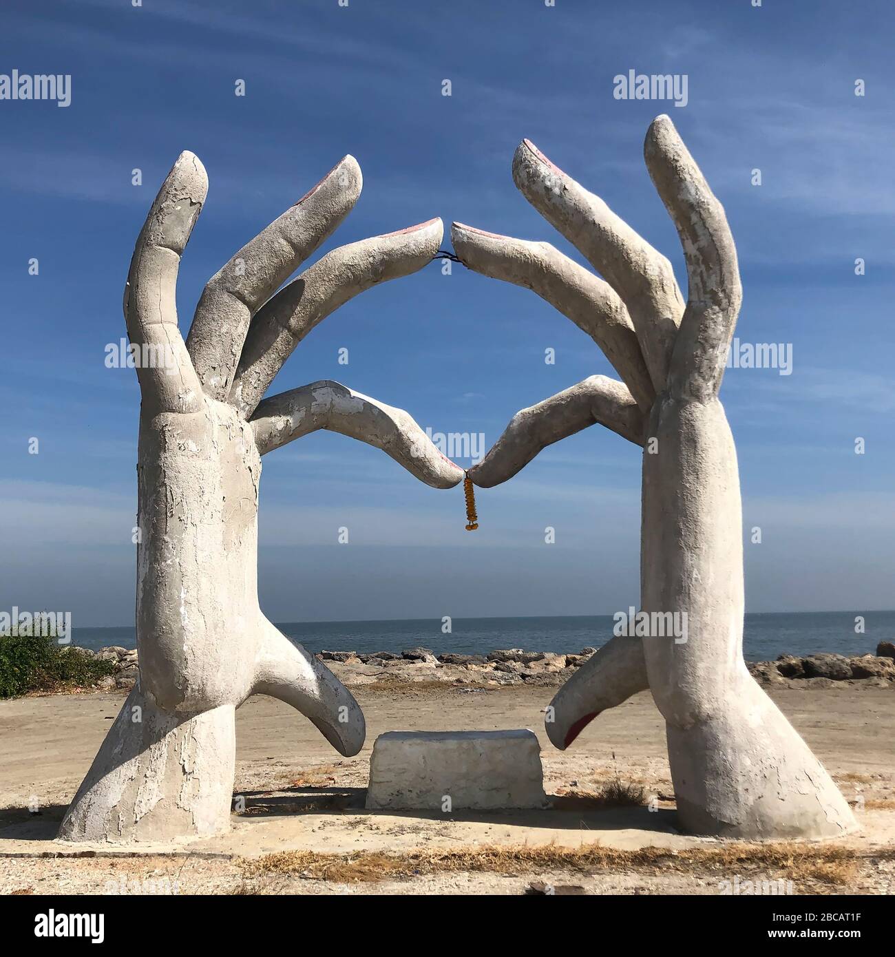 An untitled giant sculpture of hands with fingers touching along with ...
