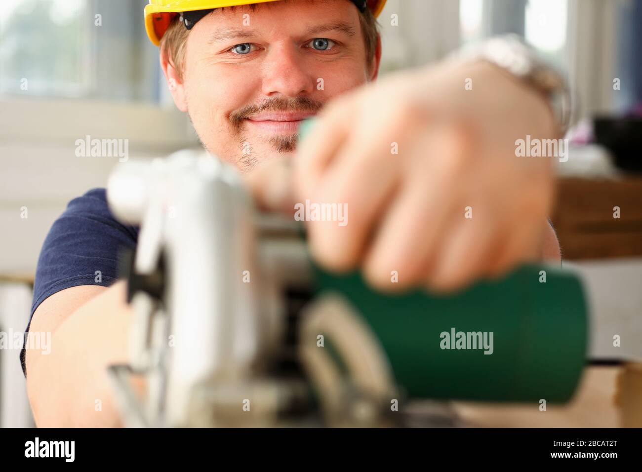 Worker using electric saw portrait Stock Photo - Alamy
