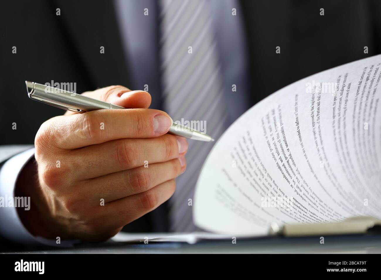 Male arm in suit and tie fill form clipped to pad Stock Photo - Alamy