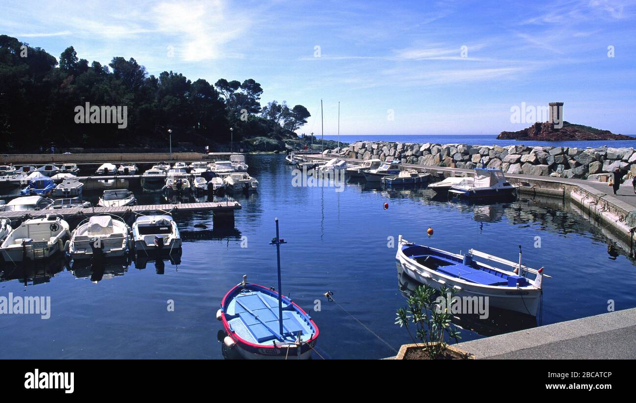 Small port of Poussaï with the golden island behind Stock Photo - Alamy