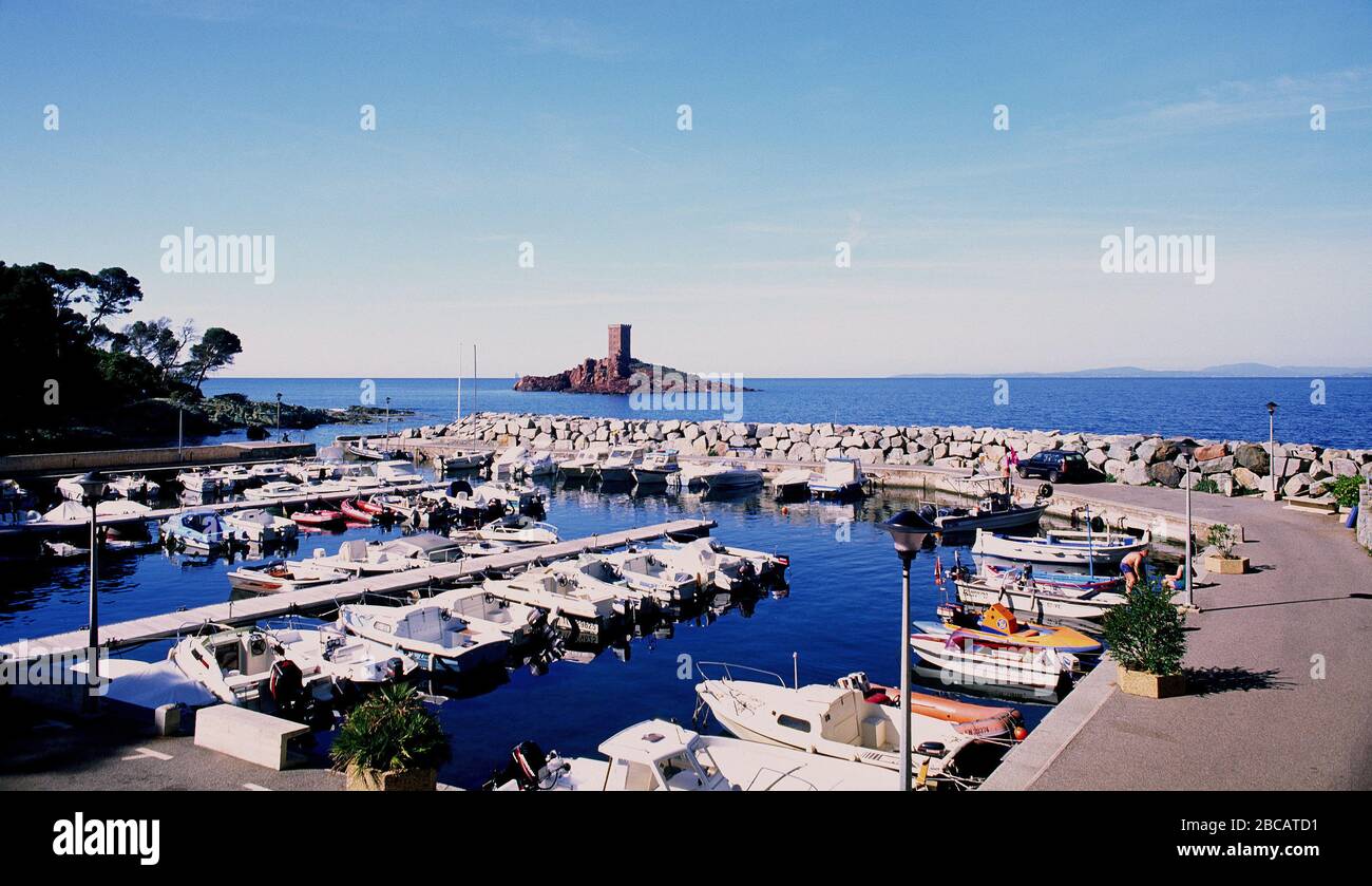Small port of Poussaï with the golden island behind Stock Photo - Alamy