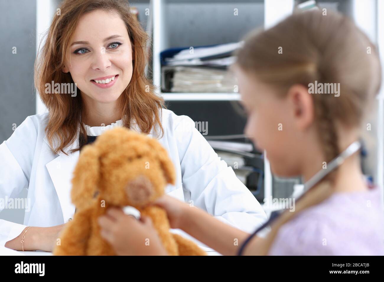 Little child with stethoscope at doctor reception Stock Photo - Alamy