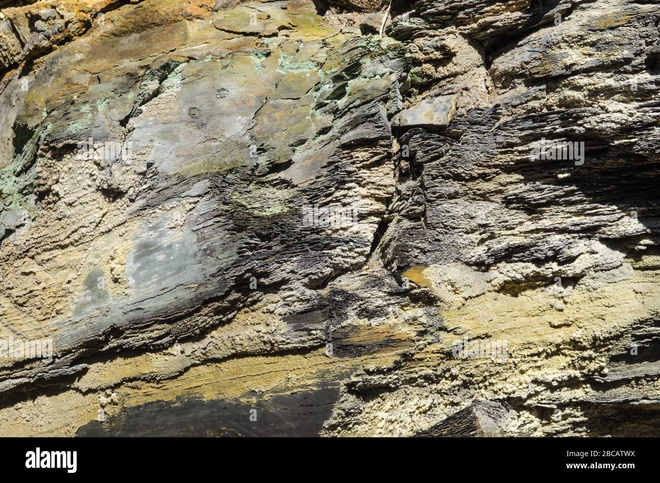 Background of sunlit weathered natural schist rock outdoors Stock Photo ...